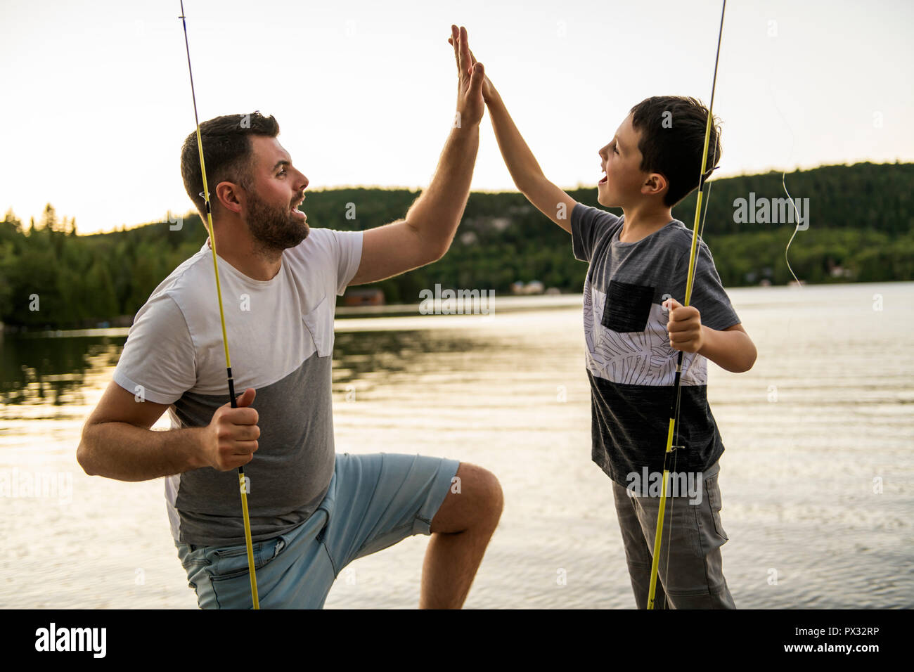 Cool Dad and son fishing on lake Stock Photo - Alamy
