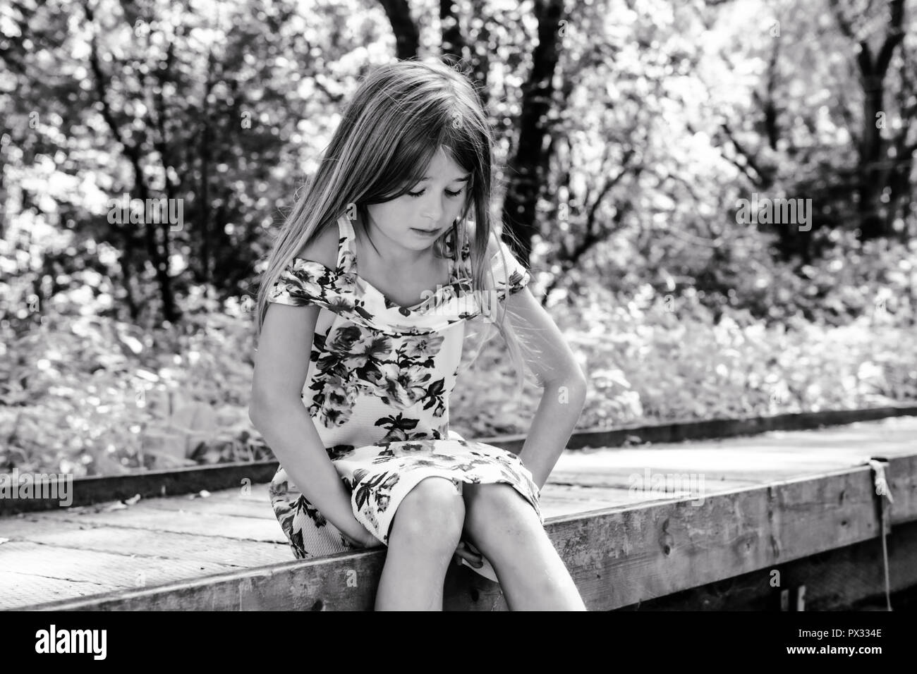 Young sad girl child alone on country forest Stock Photo - Alamy