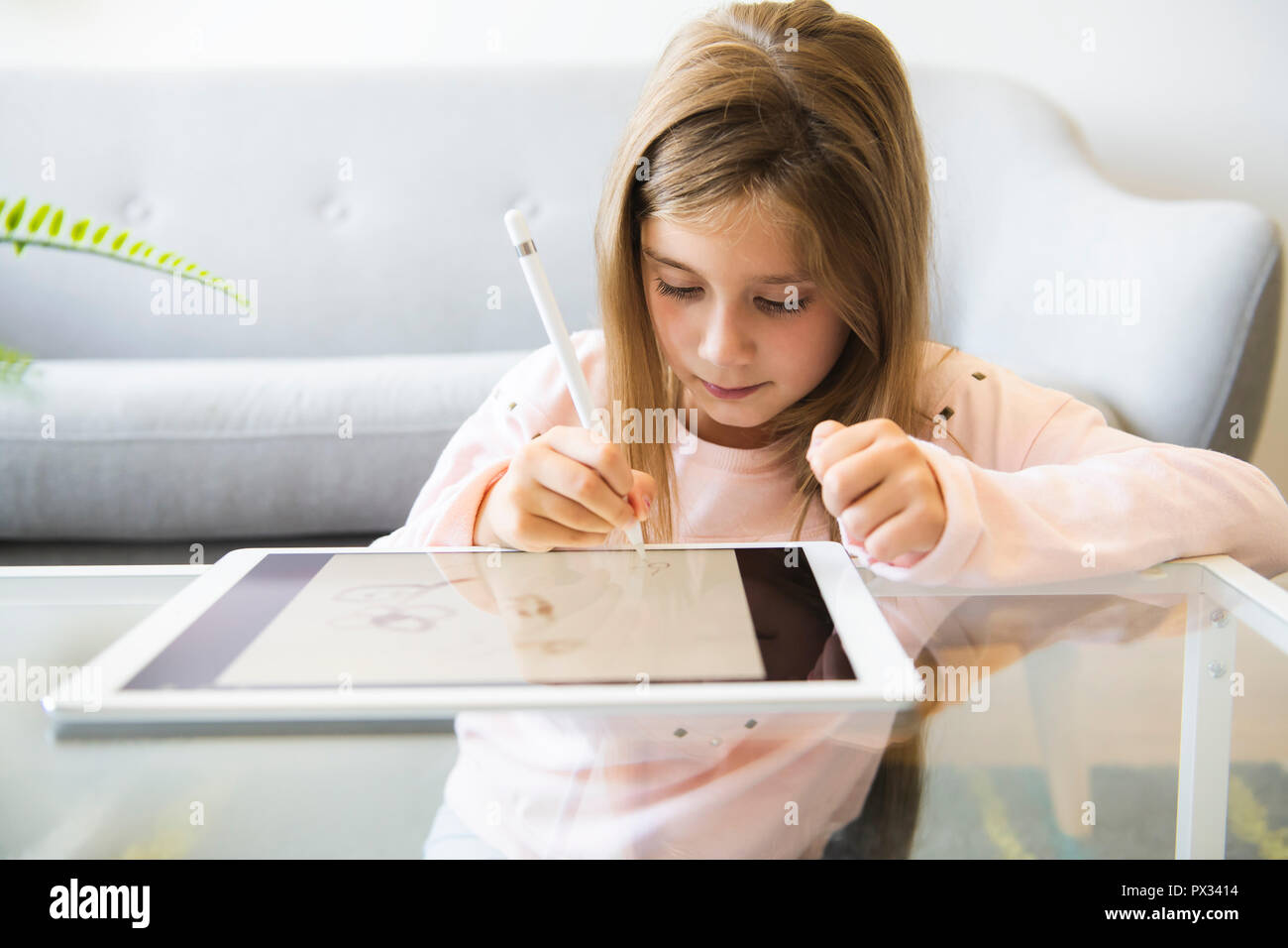 kid in living room at home and using digital tablet to draw Stock Photo ...