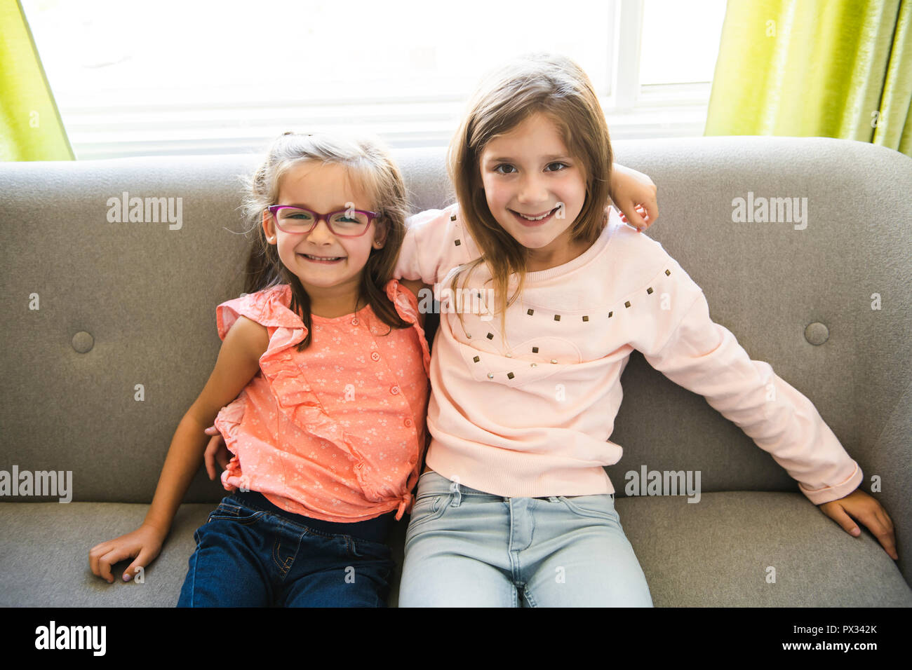 Two beautiful girls on couch hi-res stock photography and images - Alamy