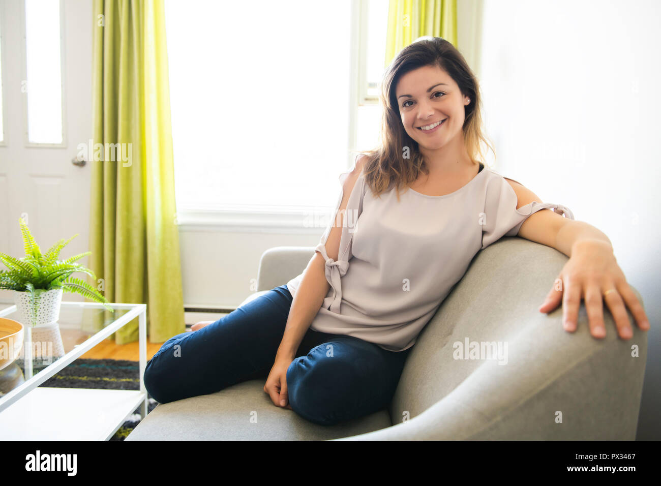 nice women sit on the sofa at home Stock Photo - Alamy