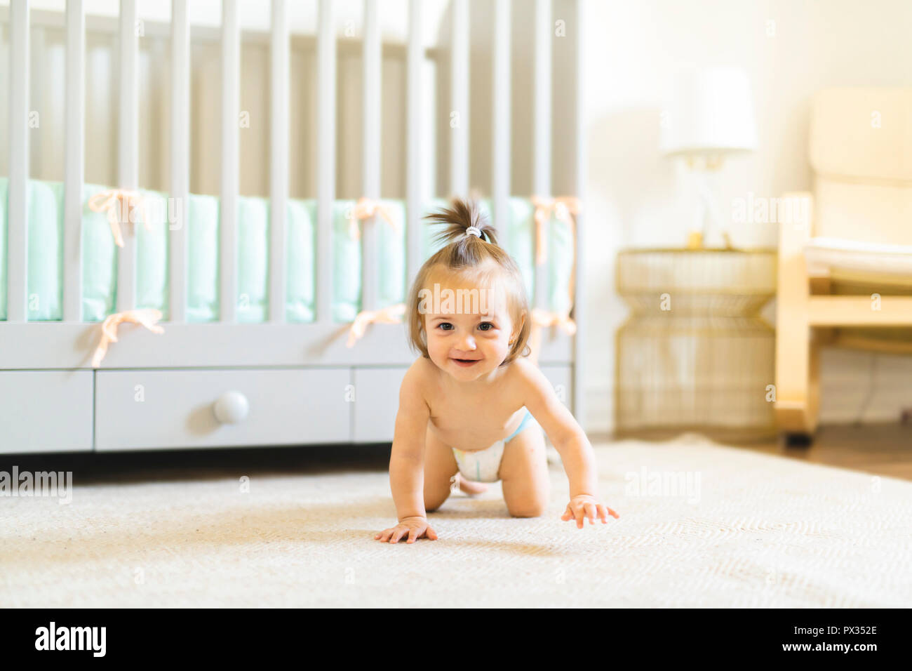 Baby taking time inside baby room crib Stock Photo - Alamy