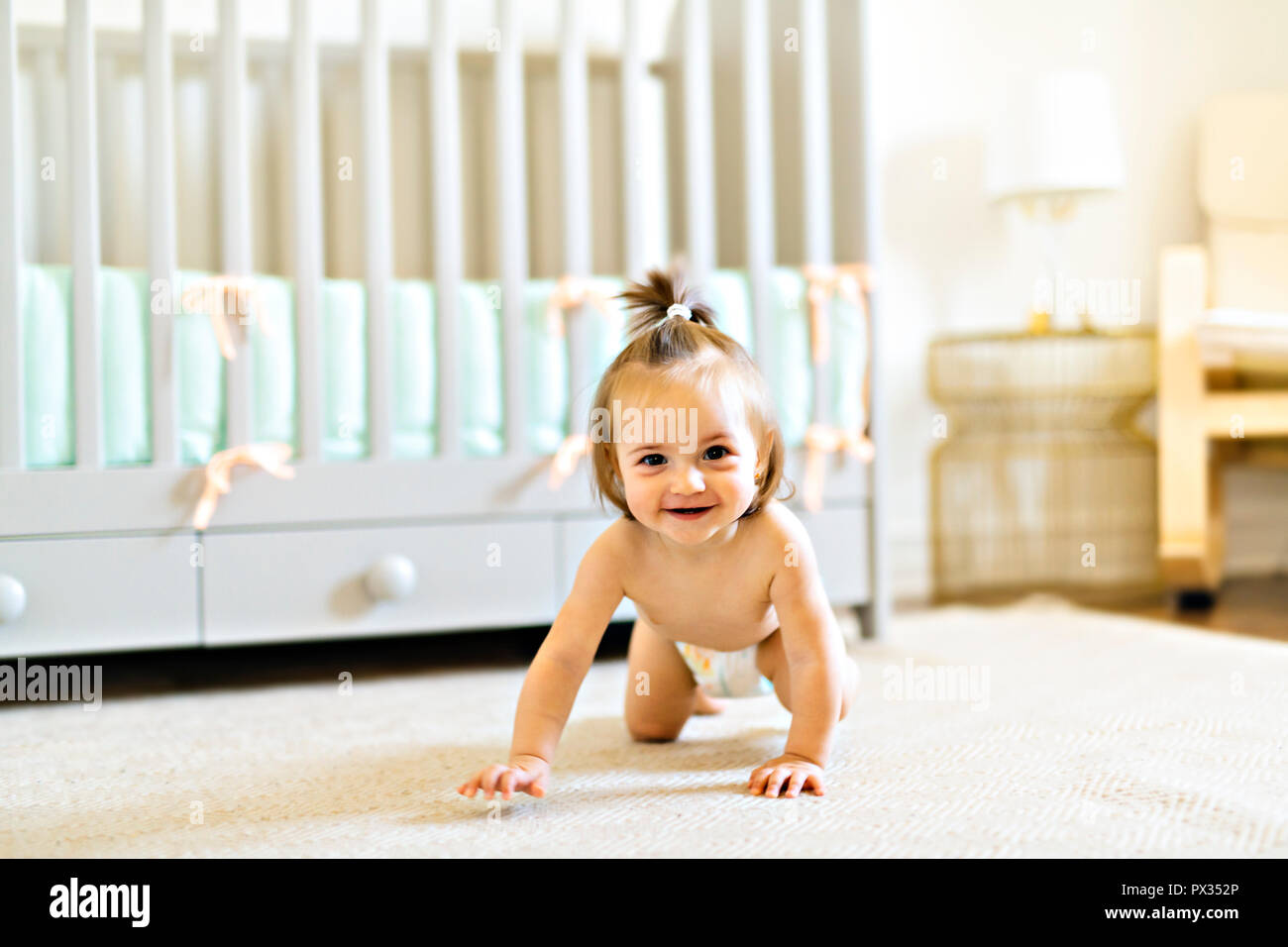 Baby taking time inside baby room crib Stock Photo - Alamy