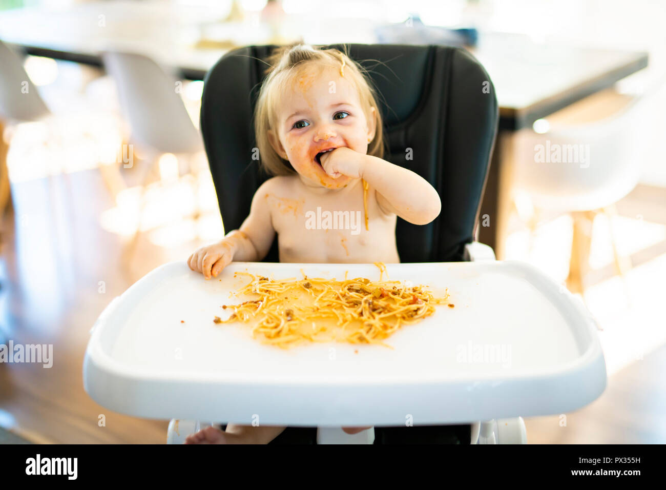 Little b eating her dinner and making a mess Stock Photo - Alamy