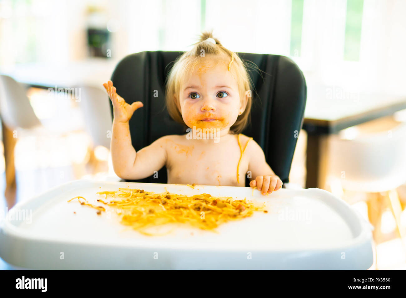 Little b eating her dinner and making a mess Stock Photo - Alamy