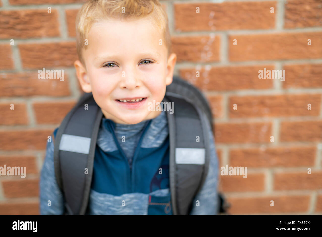A Back to school. Happy little boy with backpack Stock Photo - Alamy
