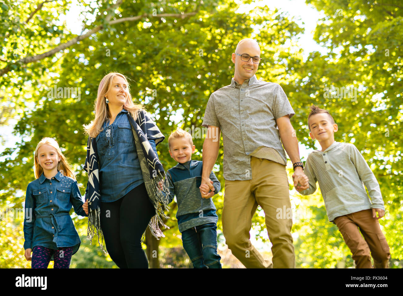 A Happy young family outside in green nature Stock Photo - Alamy