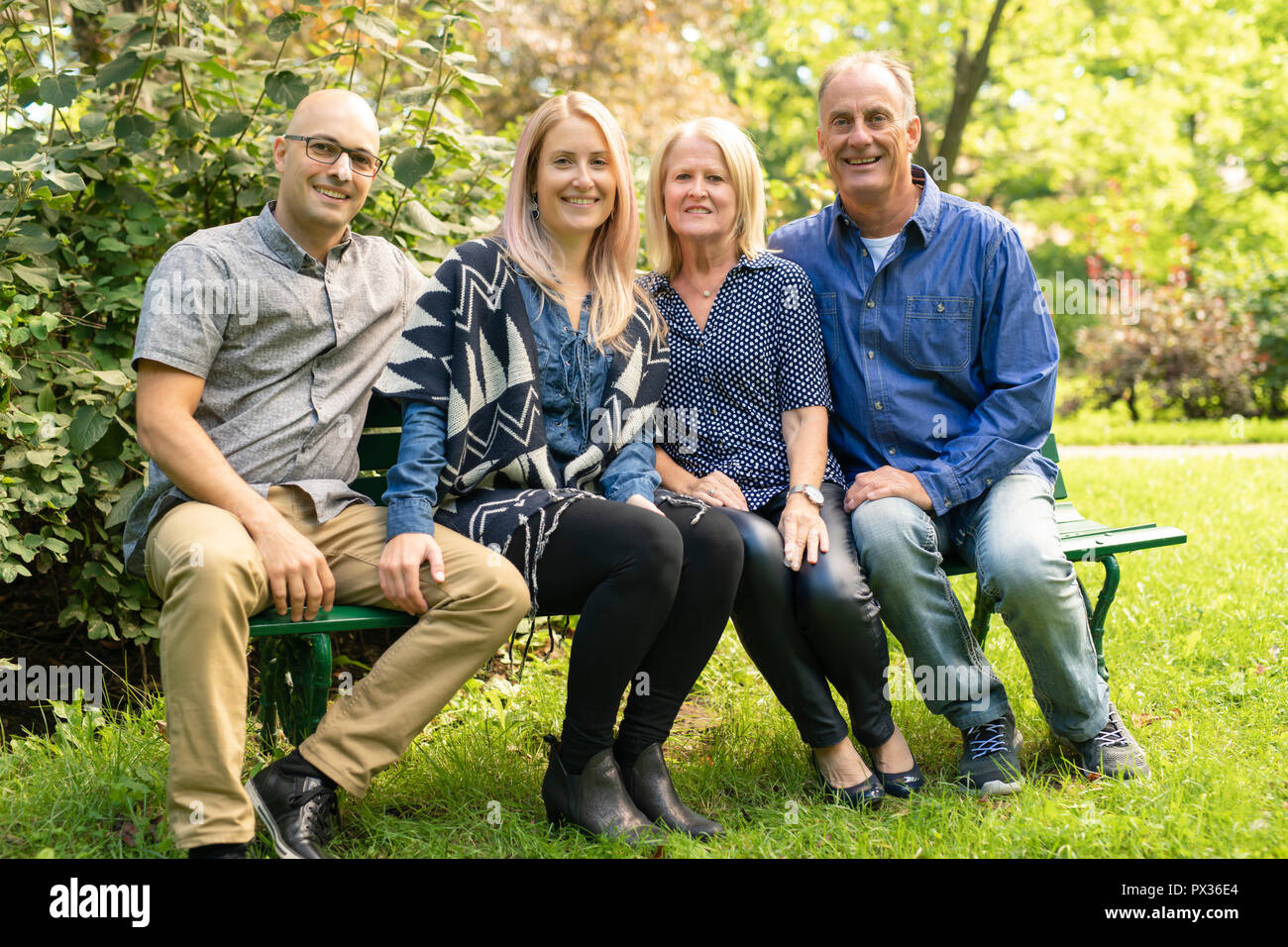 A family sit on bench a autumn season Stock Photo - Alamy