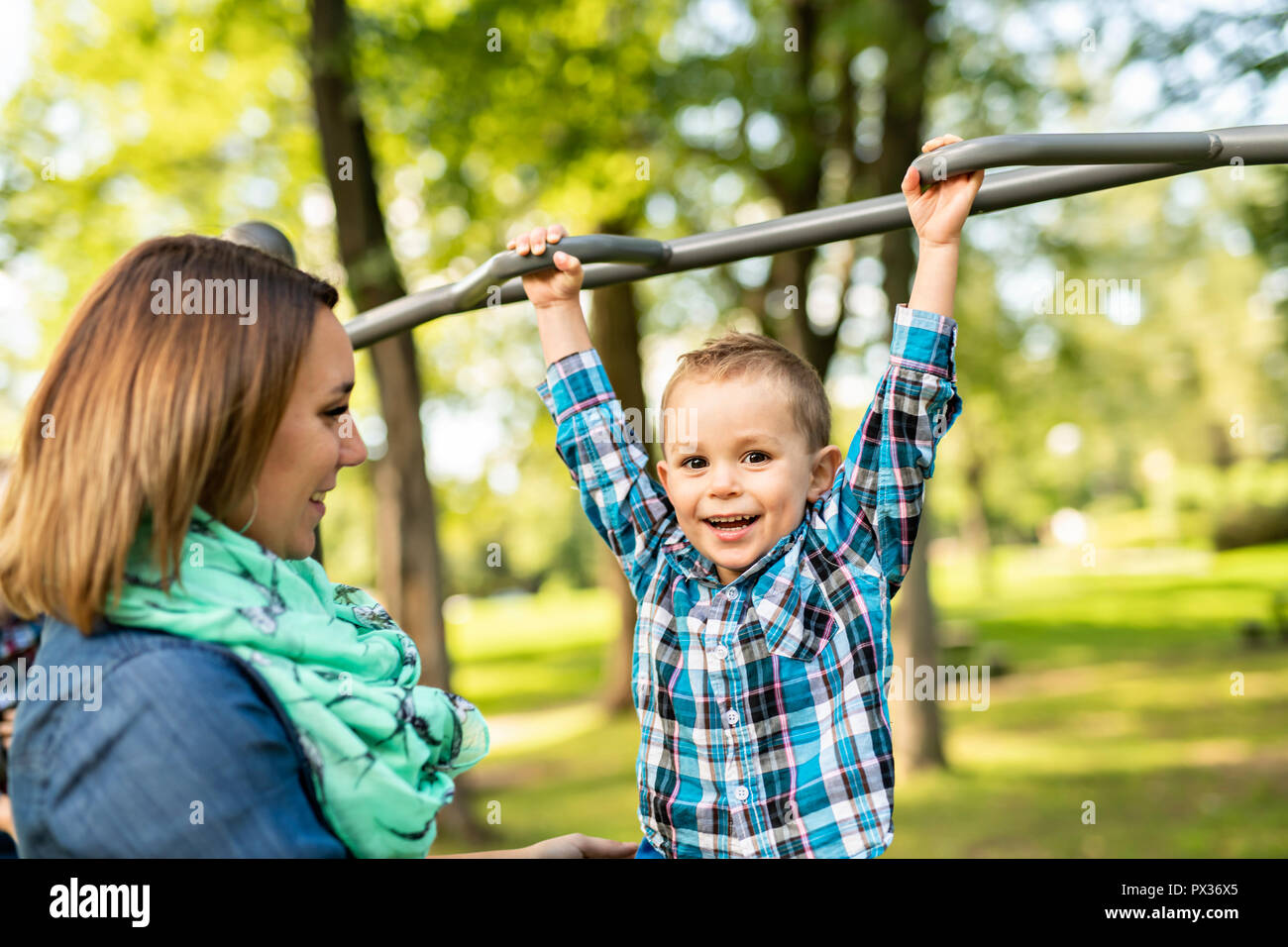 An Adorable little boy enjoying his time in a playground structure with ...