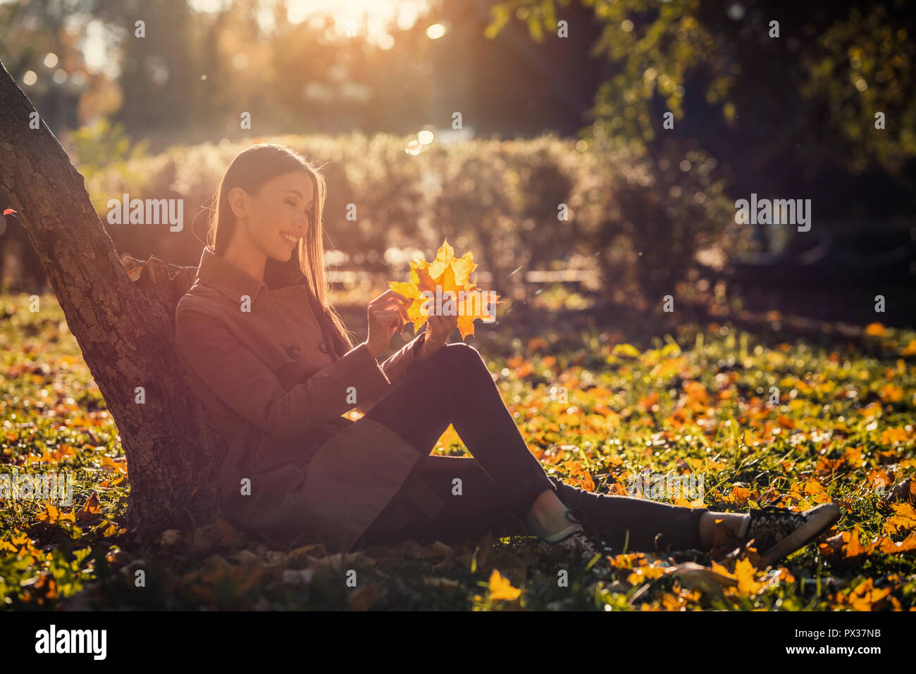 Woman during autumn, lifestyle concept. An Asian young adult female is ...