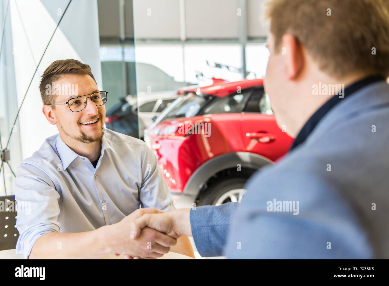 Business car seller working with the client Stock Photo - Alamy