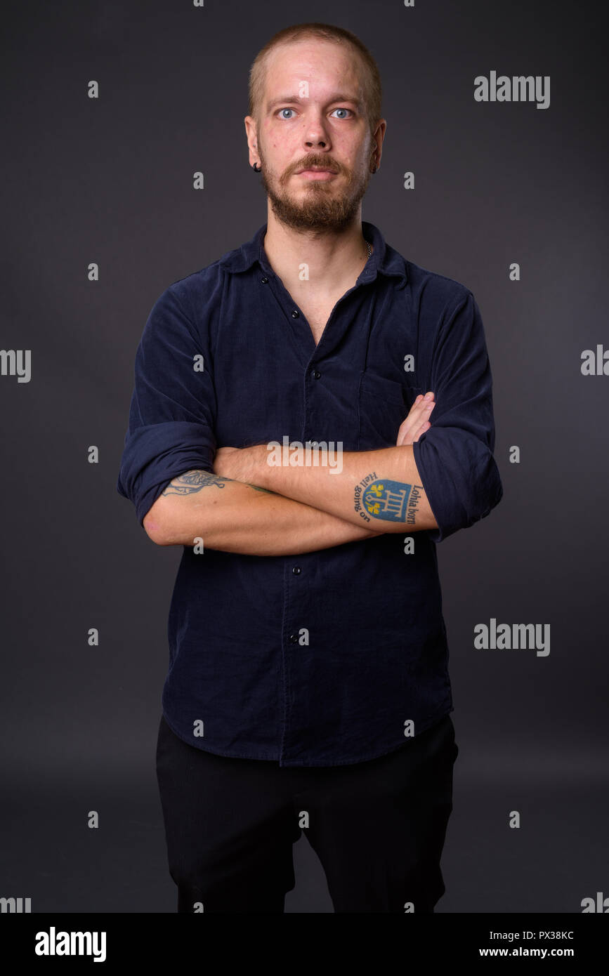 Portrait of man against gray studio background Stock Photo - Alamy