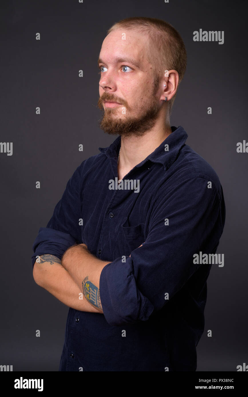 Portrait of man against gray studio background Stock Photo - Alamy