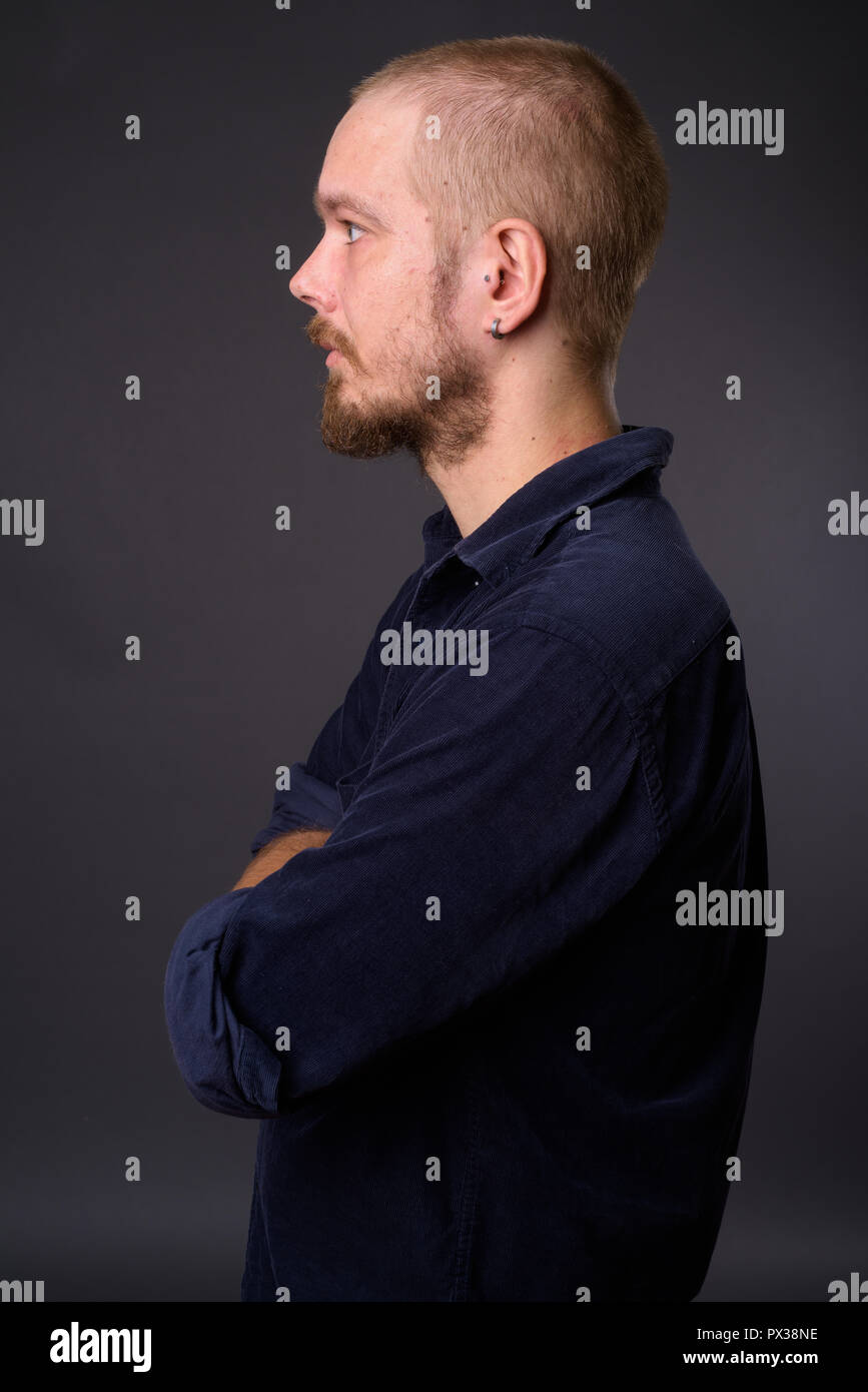 Portrait of man against gray studio background Stock Photo - Alamy
