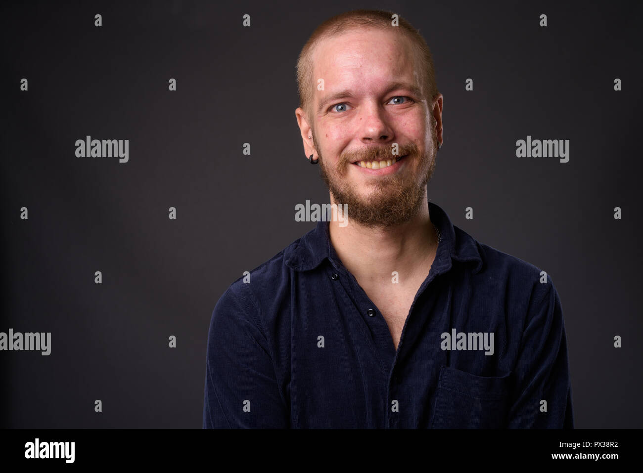 Portrait of man against gray studio background Stock Photo - Alamy