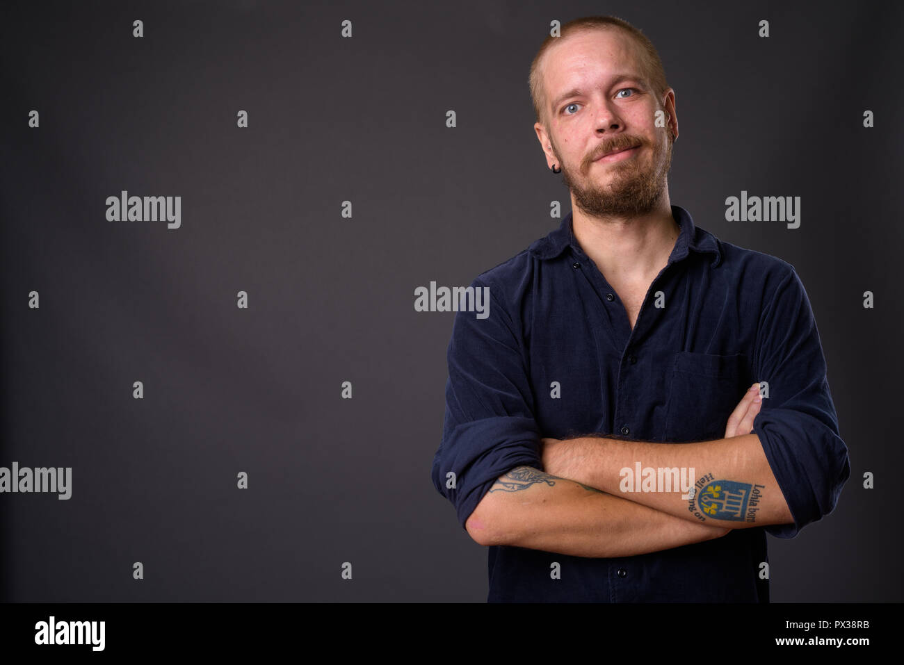 Portrait of man against gray studio background Stock Photo - Alamy