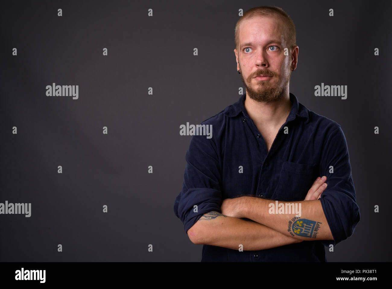Portrait of man against gray studio background Stock Photo - Alamy