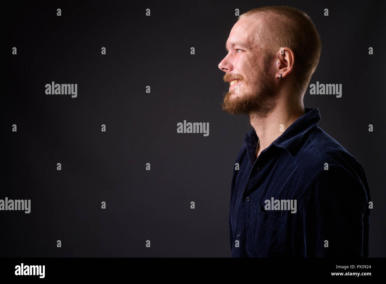 Portrait of man against gray studio background Stock Photo - Alamy