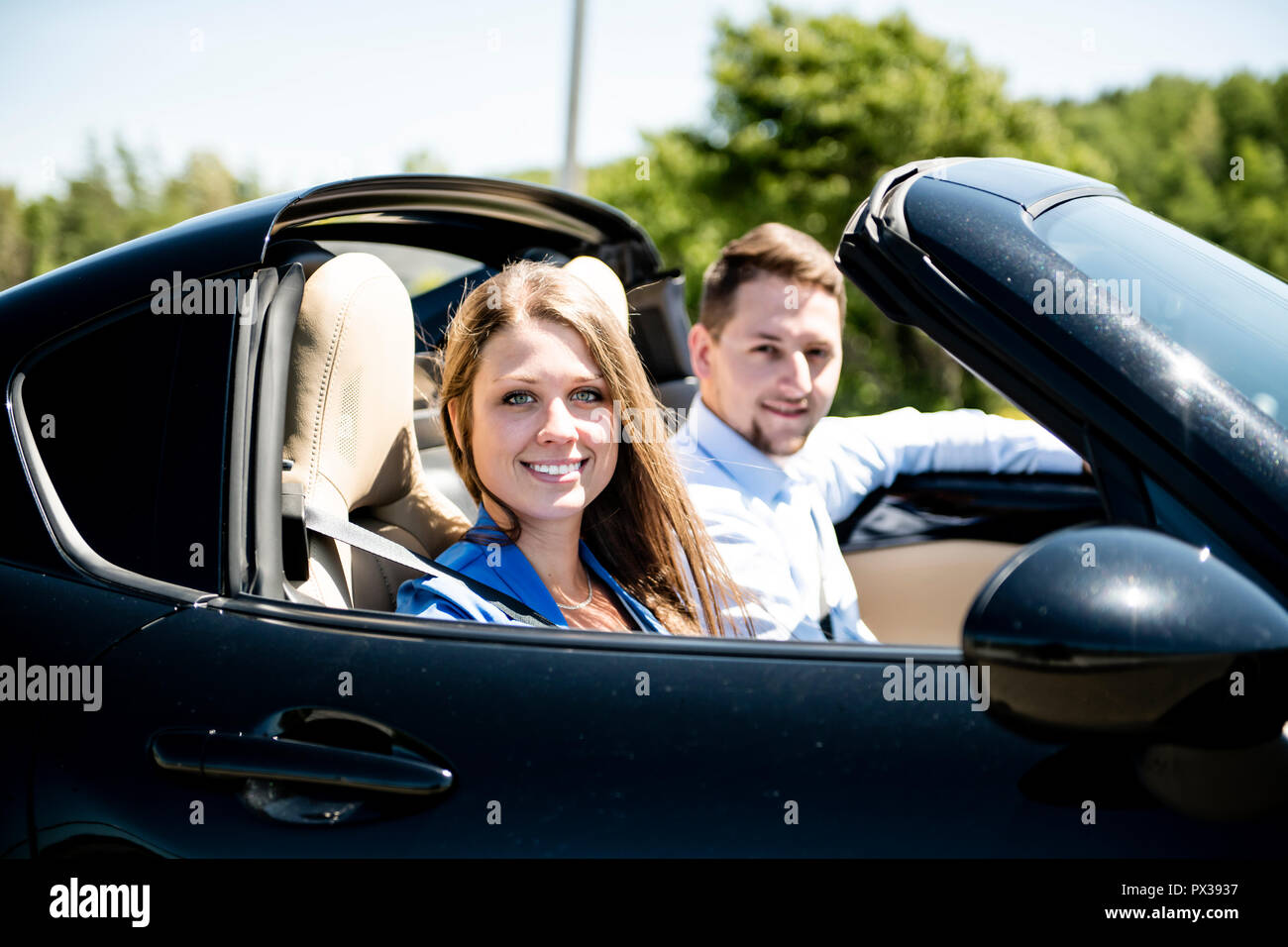 Couple enjoying a drive in a convertible Stock Photo - Alamy