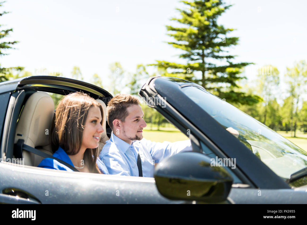 Couple enjoying a drive in a convertible Stock Photo - Alamy