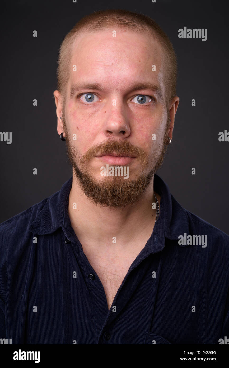 Portrait of man against gray studio background Stock Photo - Alamy