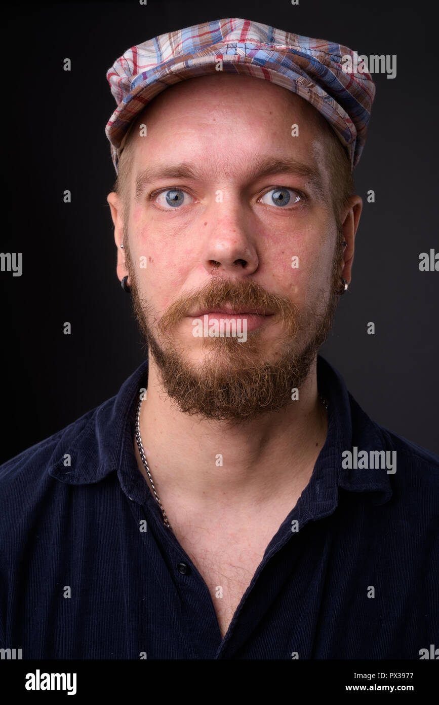 Portrait of man against gray studio background Stock Photo - Alamy