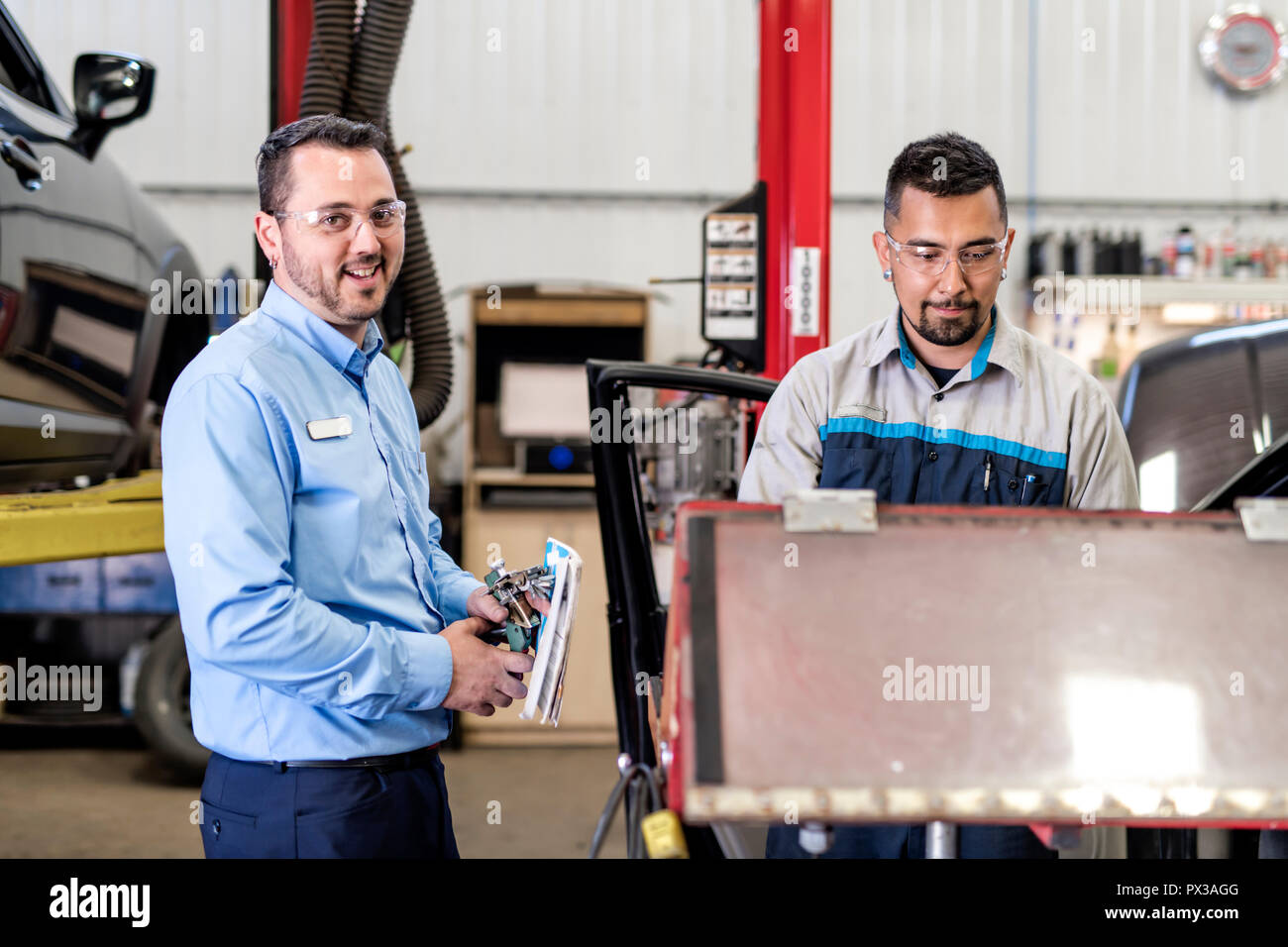 Handsome mechanics in uniform working in auto service Stock Photo - Alamy