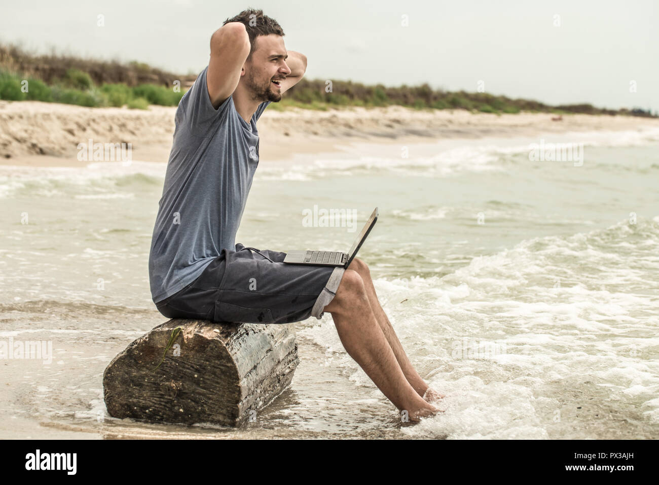 the man working at a computer in nature, work on the beach Stock Photo ...