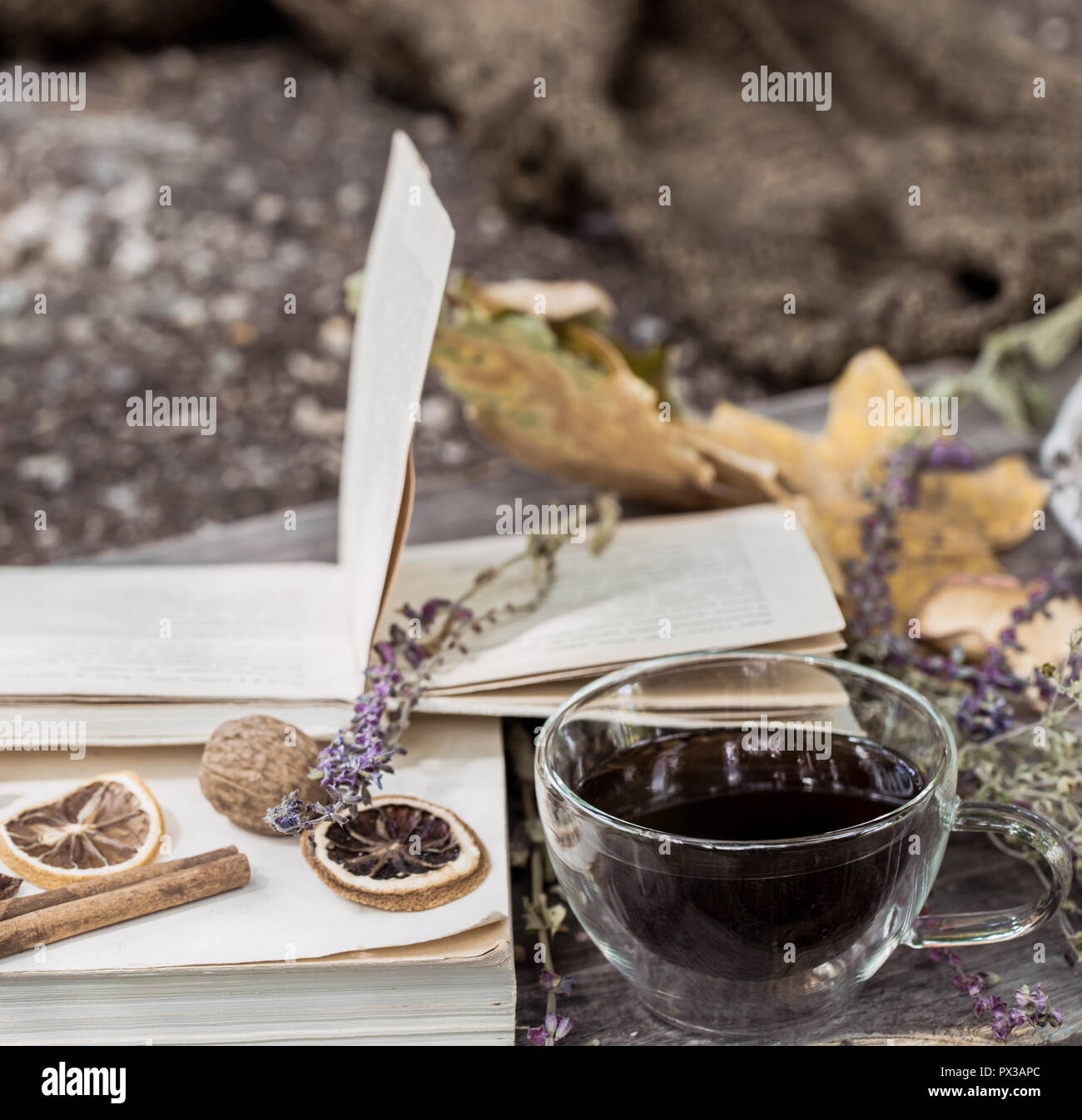 Beautiful transparent Cup of tea with autumn leaves and dried lemon on ...