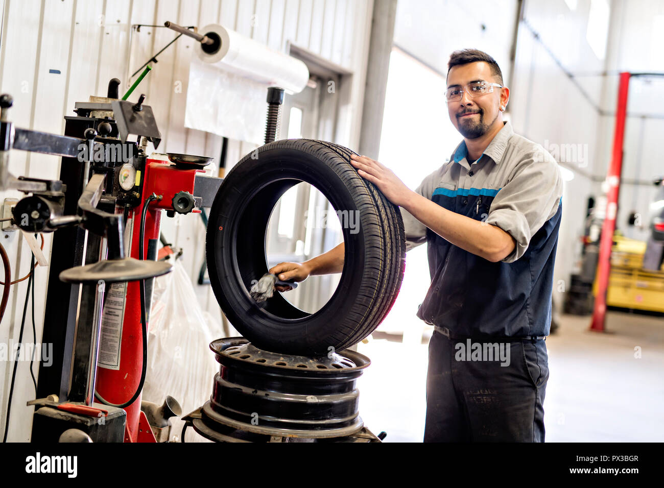 Mechanic changing car tire at work Stock Photo - Alamy