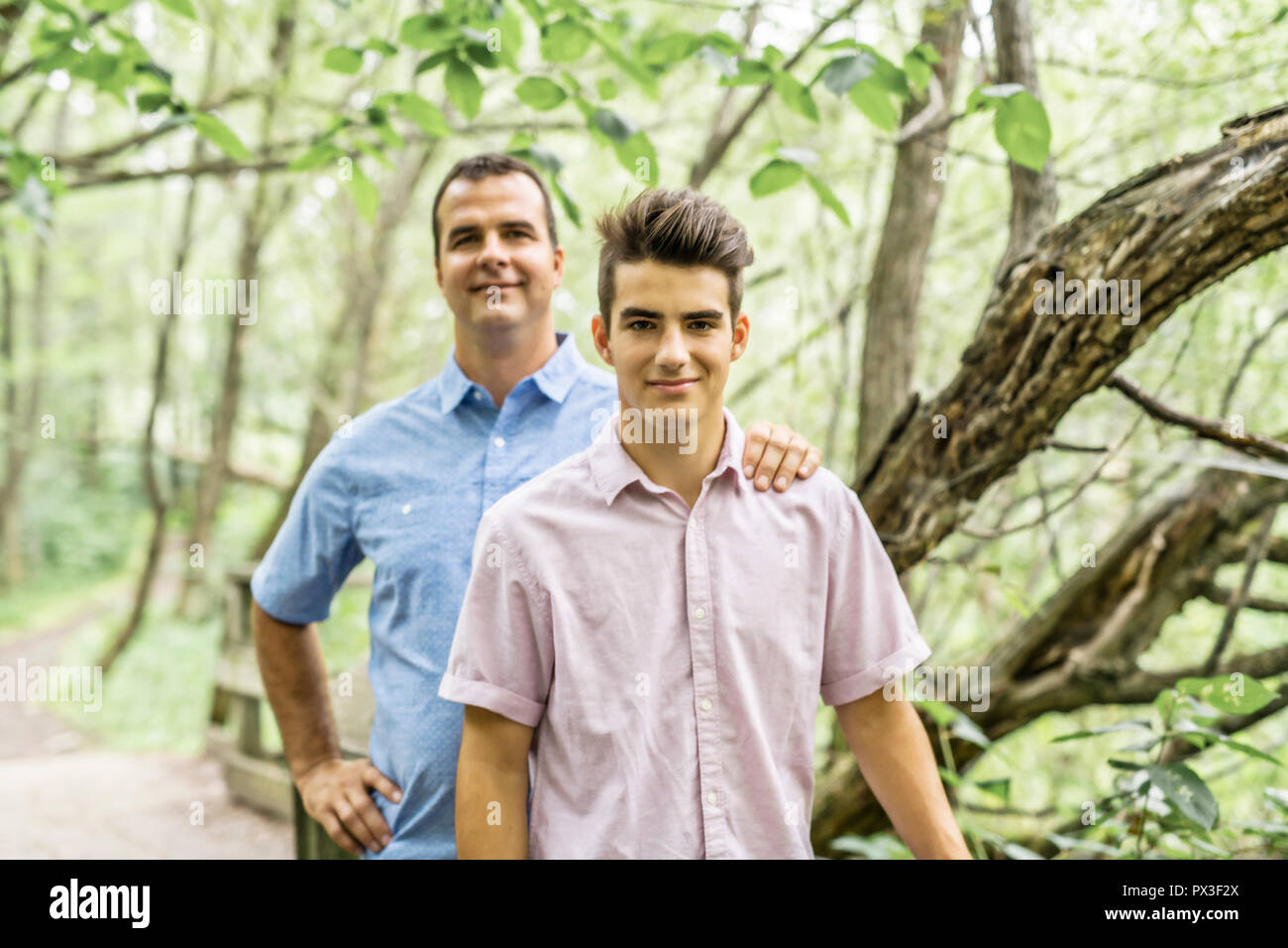 Father having fun in forest with his son Stock Photo - Alamy
