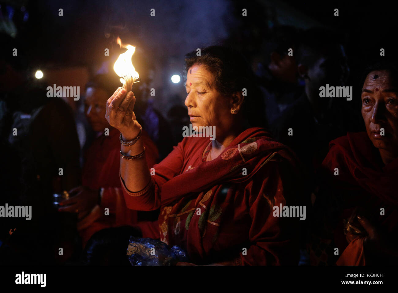 A devotee offers oil lamp as she worships at Bramahini temple during ...