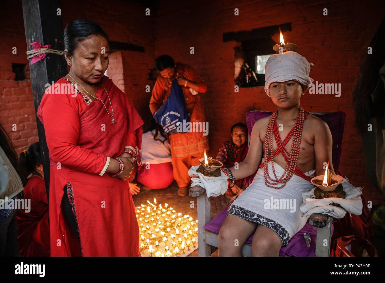 A devotee lit oil lamp on a child body as part of rituals at Branahini ...