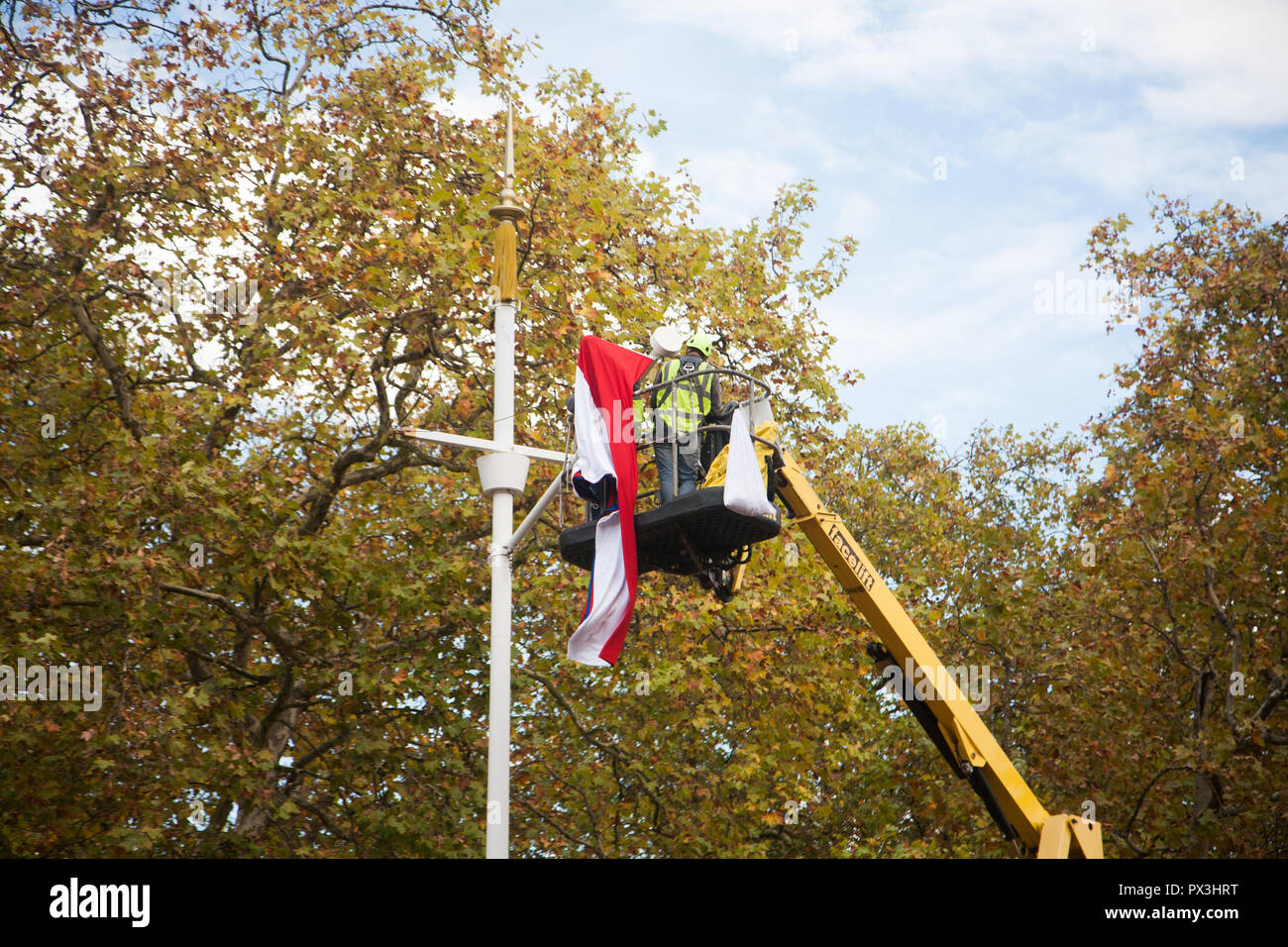 London UK. 19th October 2018. Workers on cherry pickers place Dutch ...