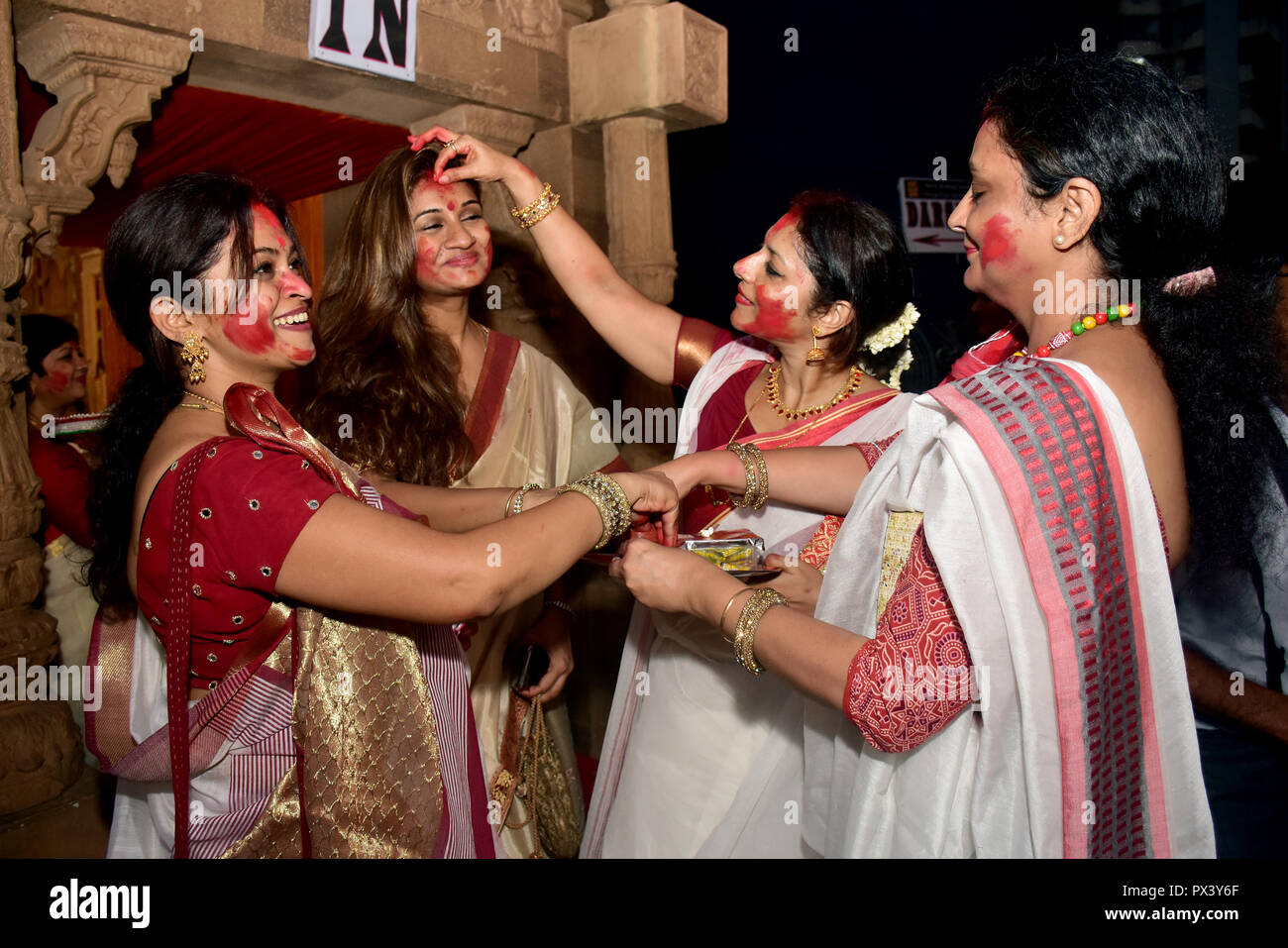 Women seen smearing one another with Sindur during the Sindur Khela ...