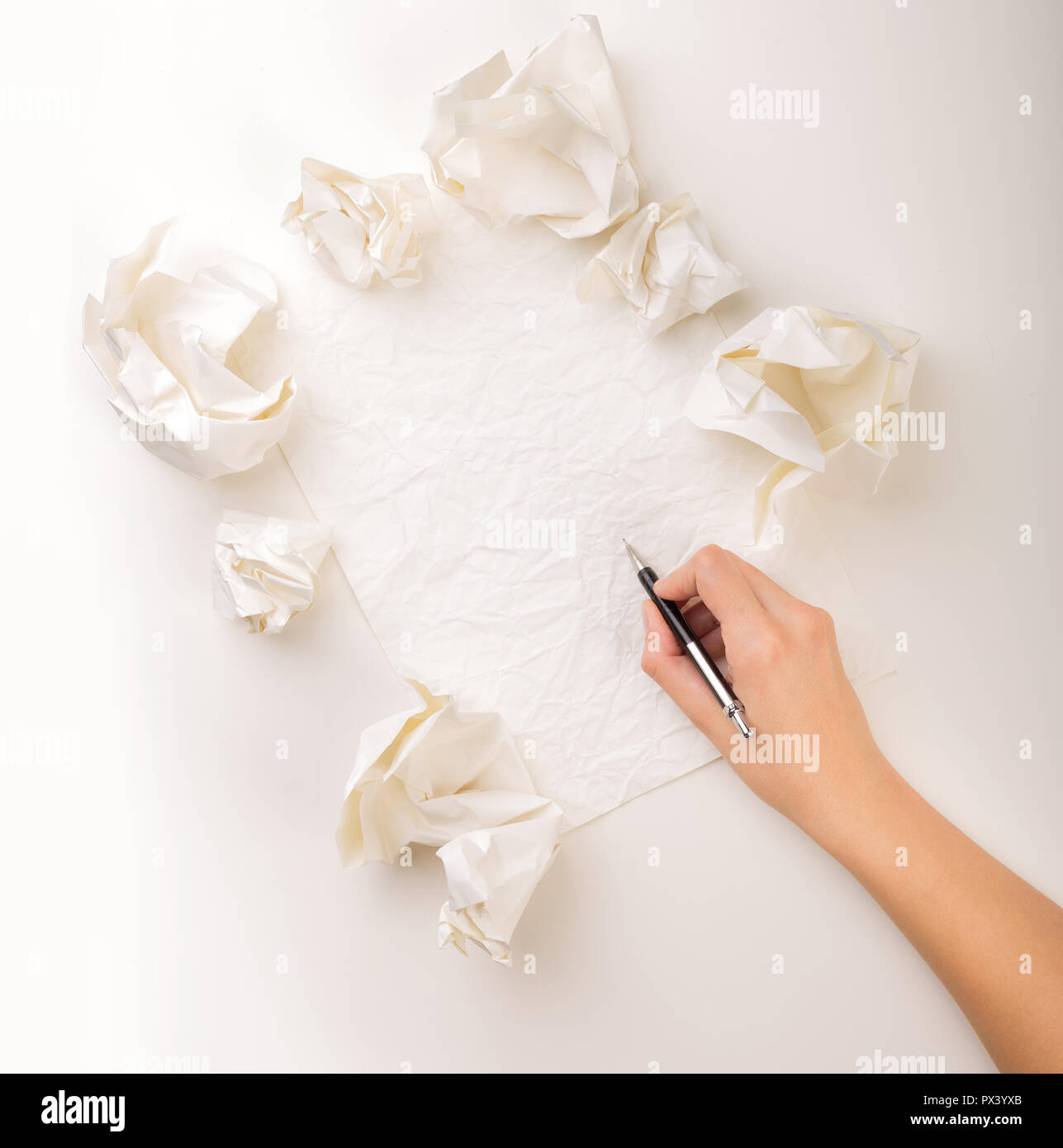 Female hand trying to write next to a few crumpled paper balls Stock ...