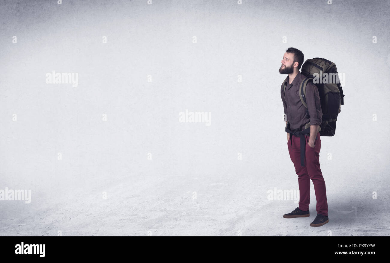 Standing handsome young man with a backpack Stock Photo - Alamy