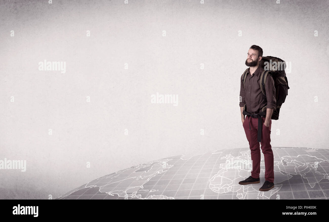 Handsome young man with a backpack on his back standing on a world map ...