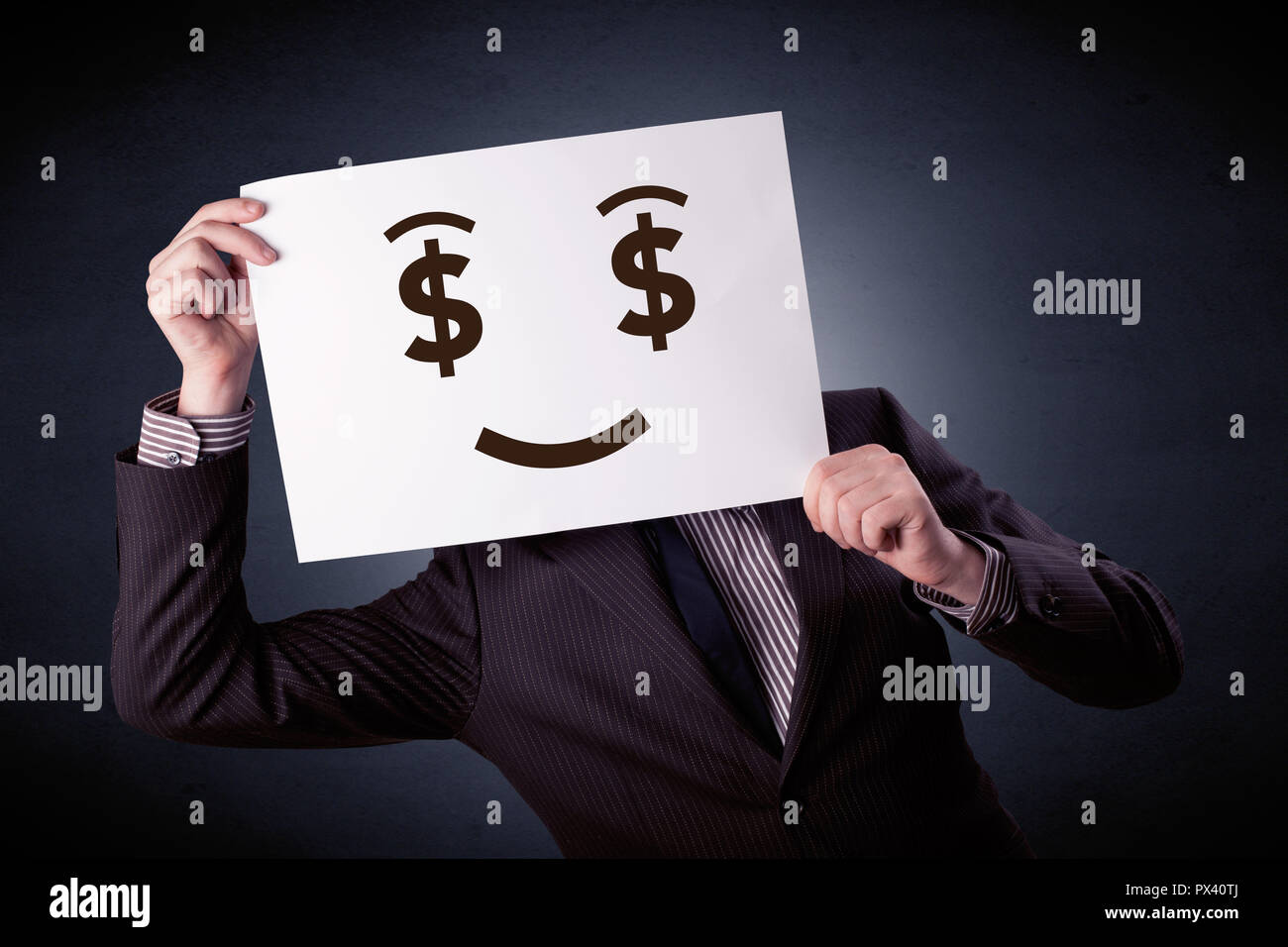Young casual businessman hiding behind a greedy face drawing on ...