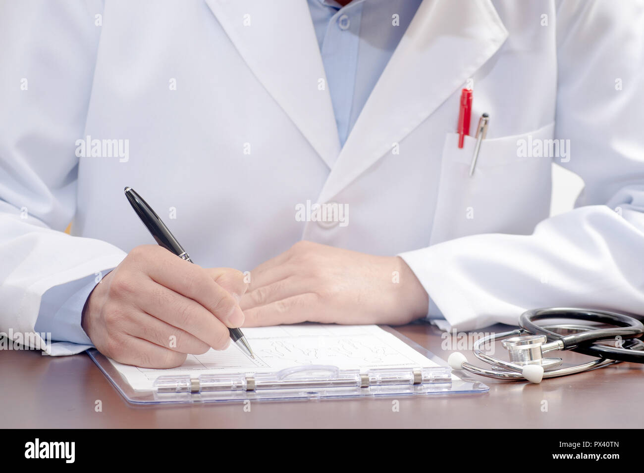 Doctor writing chart report hi-res stock photography and images - Alamy