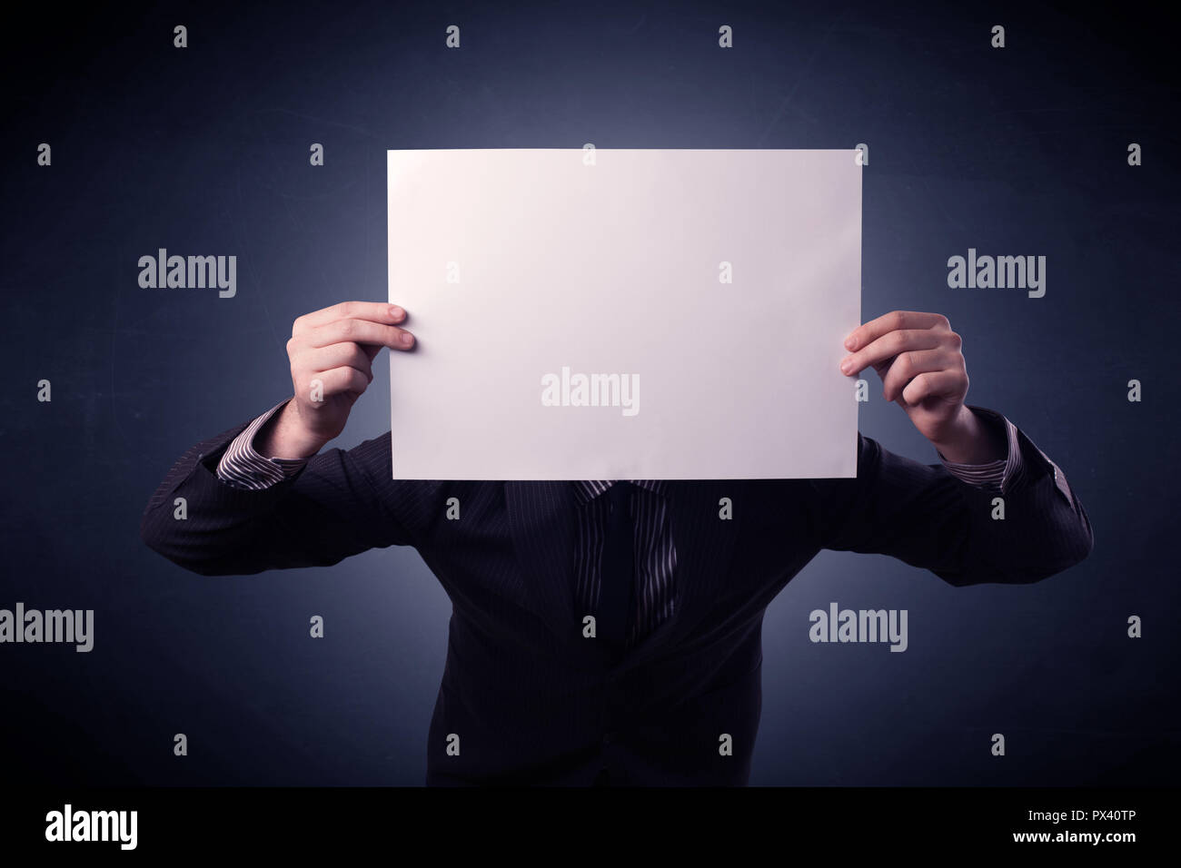 Young businessman hiding behind a blank piece of paper Stock Photo - Alamy