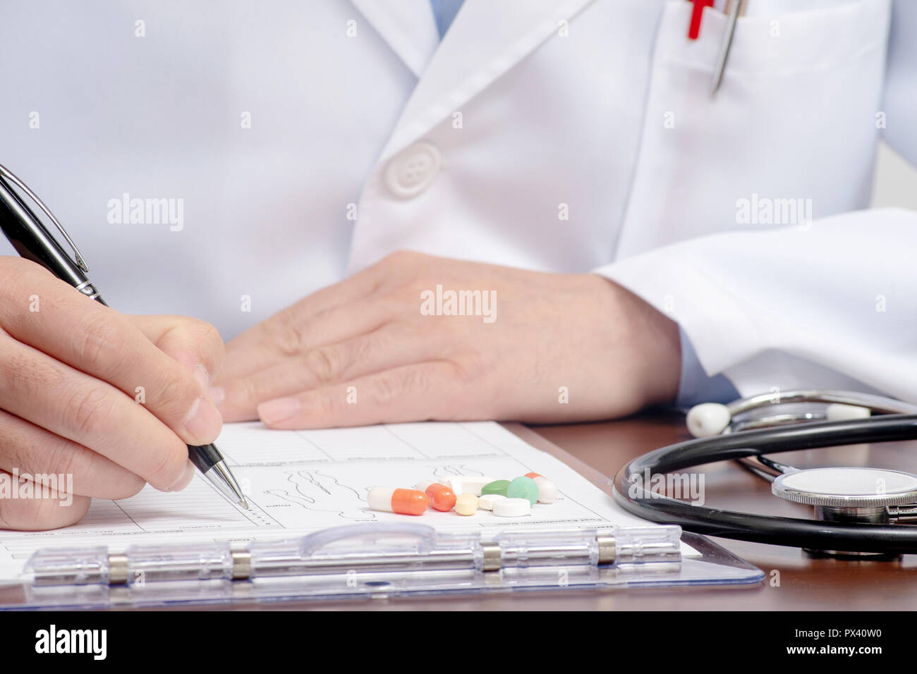 Doctor writing chart report hi-res stock photography and images - Alamy
