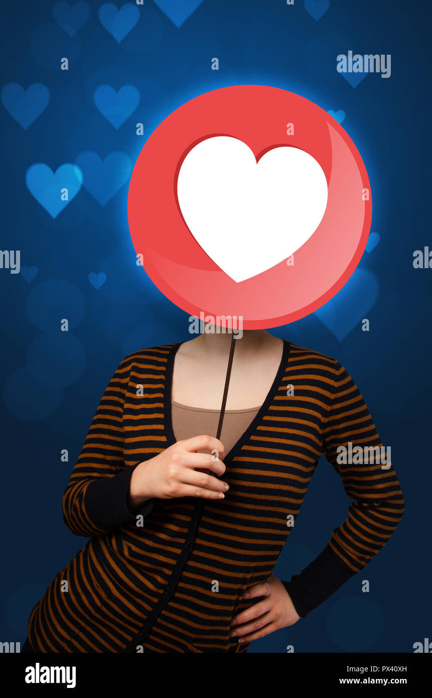 Casual young woman holding round sign with heart Stock Photo - Alamy