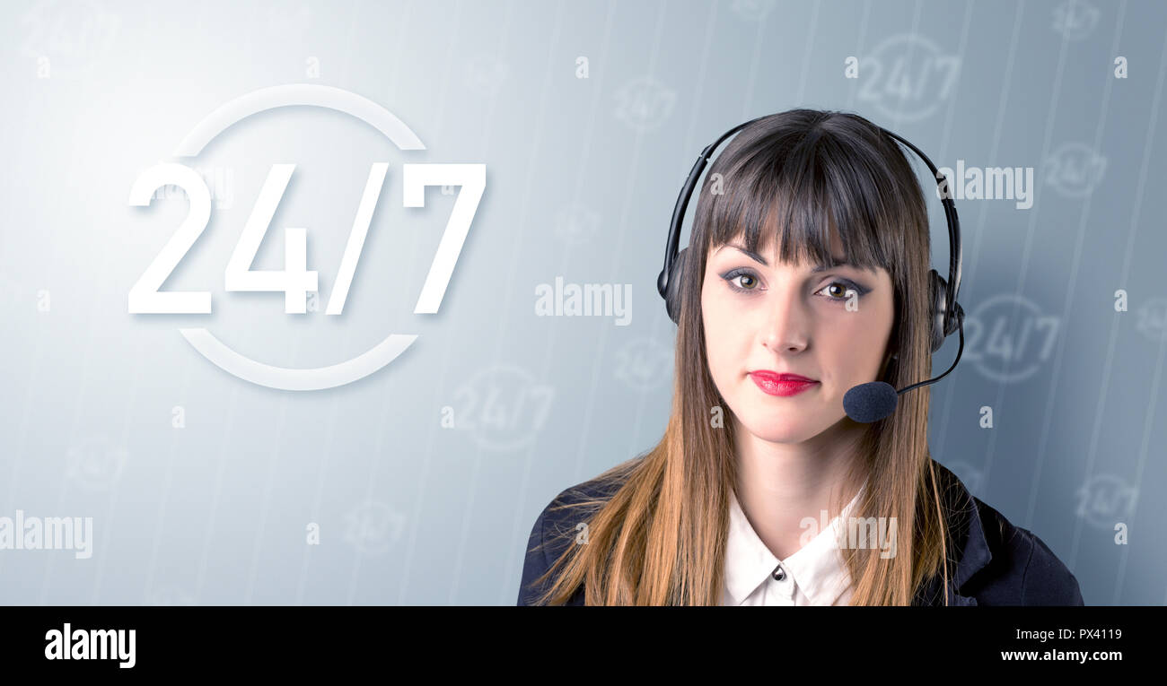 Young female telemarketer with a 24 7 sign next to her Stock Photo - Alamy