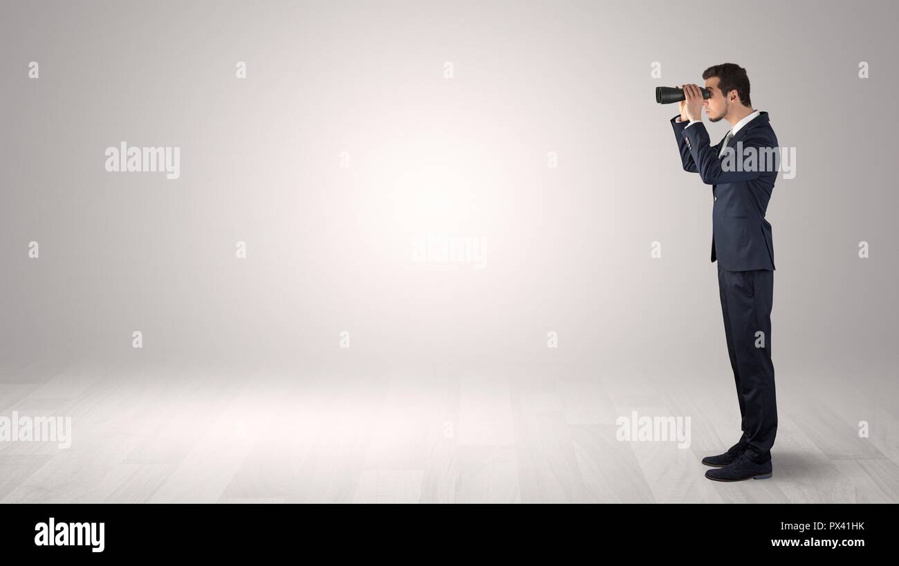 Businessman looking forward with binoculars in an empty space Stock ...