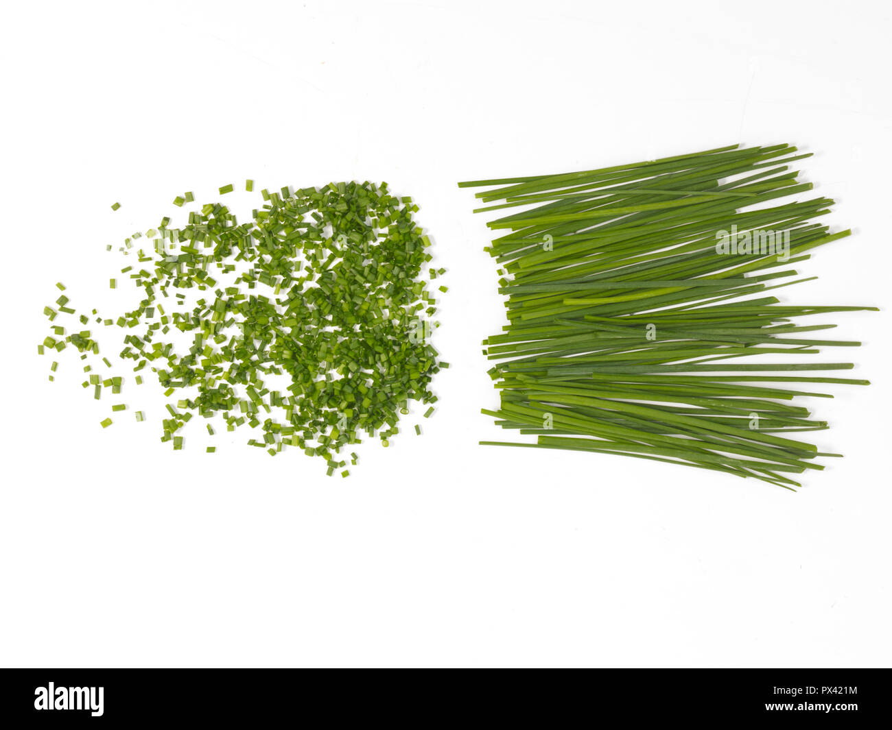 chopped and whole chives on a white background Stock Photo - Alamy