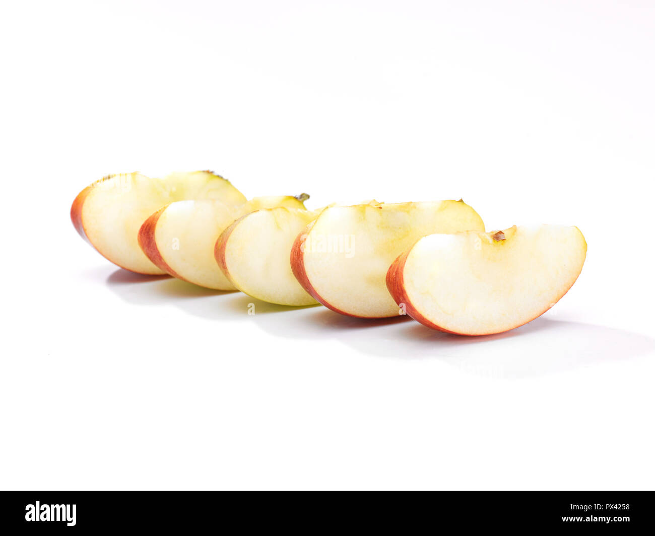 five pieces of sliced apple on a white background Stock Photo - Alamy