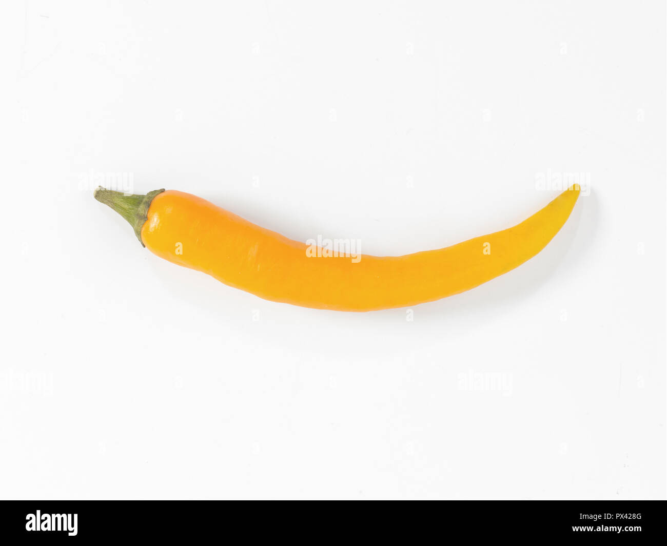 a small yellow chilli on a white background Stock Photo - Alamy