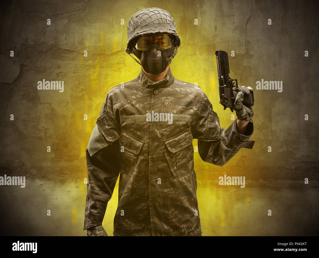 Hazard, menace soldier in a ruined crumbly building with arms on his ...