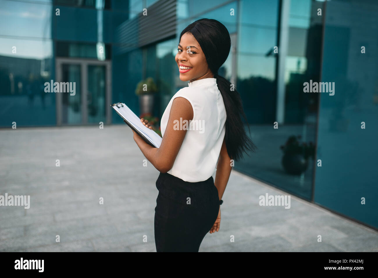 Business woman with notepad outdoors, back view Stock Photo - Alamy